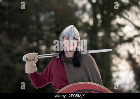 Viking shield maiden standing armed with sword and shield Stock Photo ...