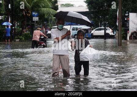 Jarkarta, Indonesia, Feb 18 2021: People walk through flood water after ...