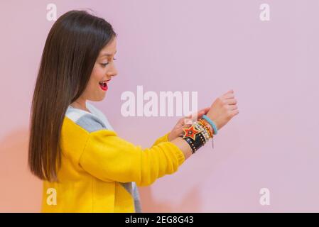 A girl trying on a white sweater in a store Stock Photo - Alamy