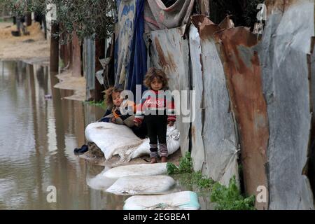 Gaza. 18th Feb, 2021. Palestinian children play outside their house in ...