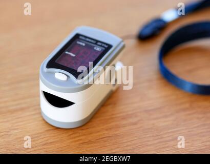 Checking oxygen level at home with home oximeter, patient measuring the ...