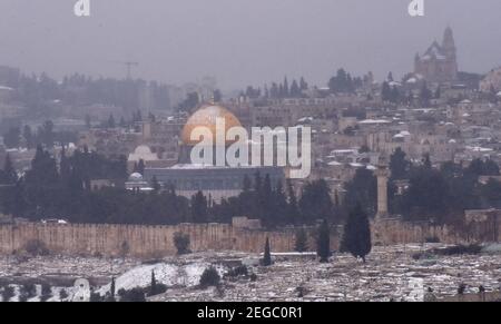 Jerusalem, Israel. 18th Feb, 2021. Snow covers the Jewish cemetery on ...