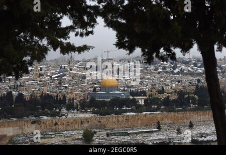Jerusalem, Israel. 18th Feb, 2021. A man looks at snow on the Dome of ...
