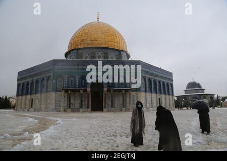 Jerusalem. 18th Feb, 2021. People play near the Dome of the Rock after ...