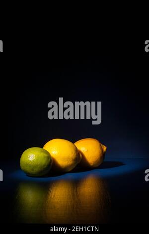 Lemons and lime on blue backdrop Stock Photo - Alamy