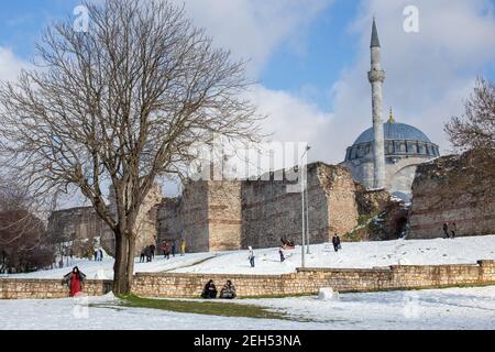 Women, snow and building a snowman in winter during Christmas while ...