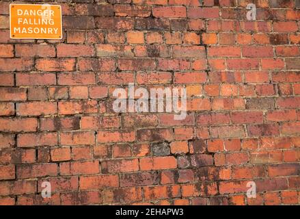 Beware falling masonry warning sign in a churchyard at Brancaster ...