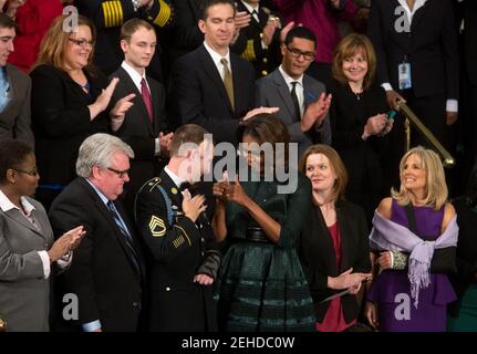 Army Ranger Sgt. First Class Cory Remsburg is applauded by his father ...
