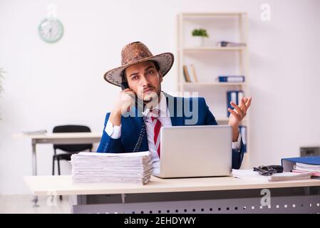 Businessman cowboy working in the office Stock Photo - Alamy