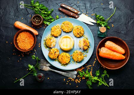 Tasty fried vegetarian carrots cutlets with greens served at plate ...