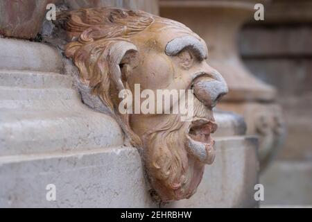 A gargoyle in shape of a human face of the water fountain built in 1903 ...