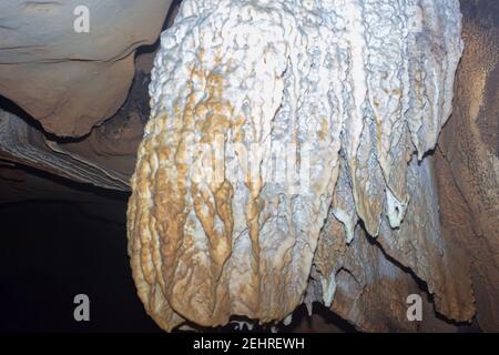 Speleology. Old cave washed by an underground river in the mountain ...