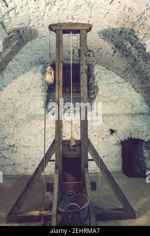 Ancient guillotine in the basement of the castle. Tool to apply the ...