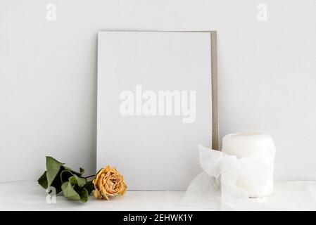 Blank card with envelope, flowers and necklace on light background ...