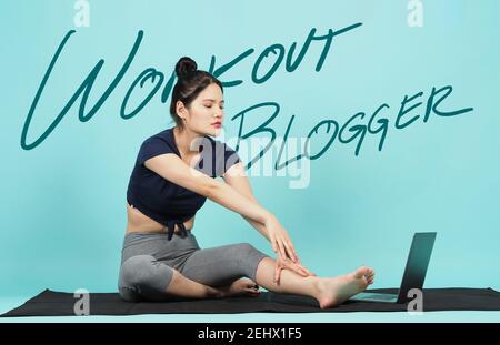 Fitness influencer. Sporty woman workout training online via laptop ...