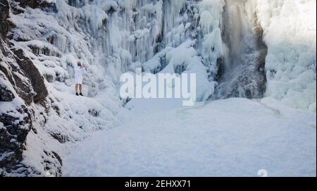 Man in traditional Japanese shugendo outfit doing waterfall meditation ...
