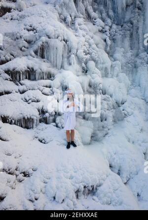 Man in traditional Japanese shugendo outfit doing waterfall meditation ...