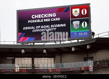 A VAR check for a possible red card is shown on screen following a foul ...