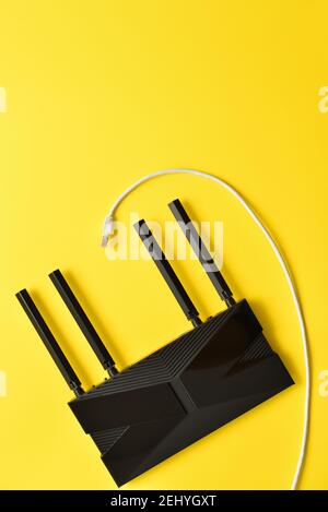 wireless router with yellow internet cable on white background Stock ...