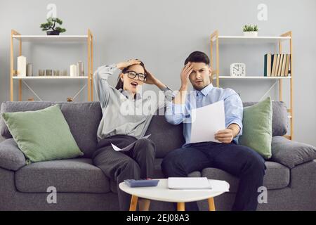Young couple looking at family finance papers Stock Photo - Alamy