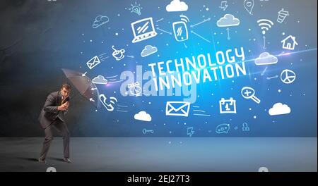 Businessman defending with umbrella from TECHNOLOGY INNOVATION ...
