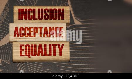 Diversity, equality, inclusion words written on torn paper with blue ...
