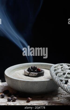 Burning juniper berries ( Juniperus communis) in shell with sand Stock ...