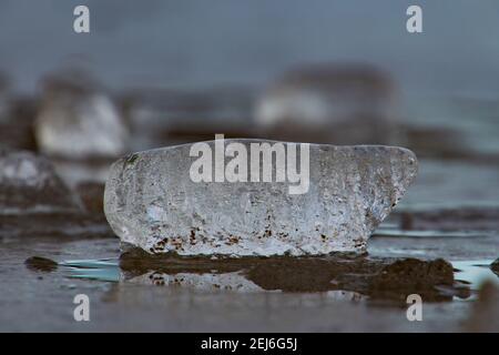 Side view of ice block laying on ice surface, selective focus Stock ...