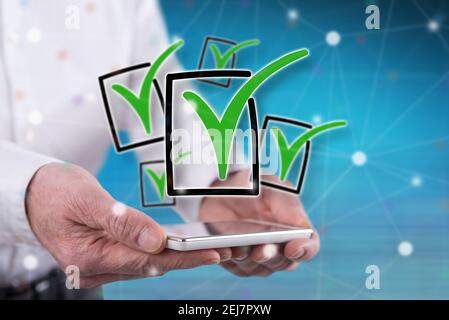 Vote concept above a smartphone held by a man Stock Photo - Alamy