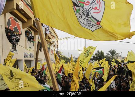 Palestinians waving yellow Fatah flags during a rally marking the 55th ...