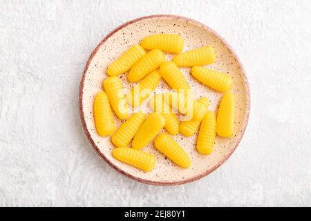 Jelly corn candies on gray concrete background and linen textile. top ...