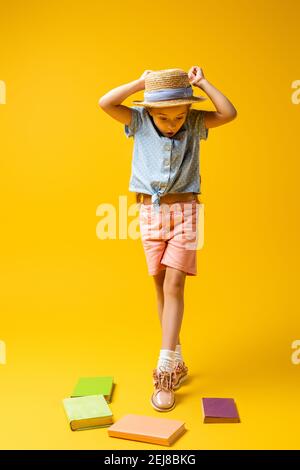 surprised happy child in straw hat and sunglasses with long brunette ...