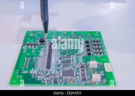 Automatic manipulator with dispenser needle during work with SMT pcb ...