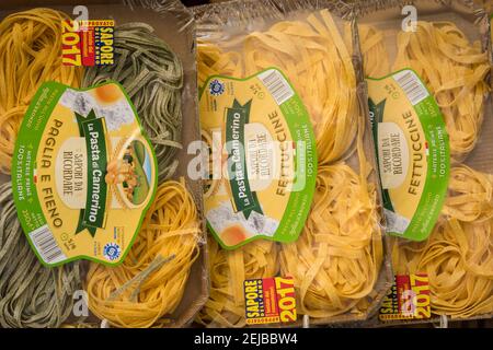Packets of dried tagliatelle pasta for sale in a shop window in Bologna ...