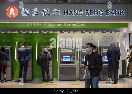 Clients at the Hang Seng Bank ATM in Central MTR subway in Hong Kong ...