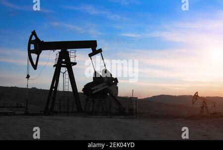 Oil drilling derricks at moutain oilfield for fossil fuels output and ...
