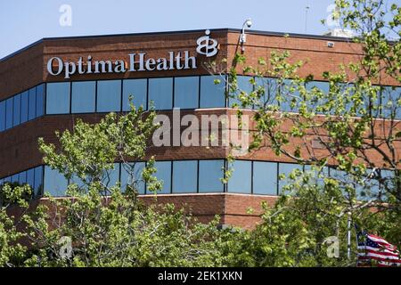 A logo sign outside of the headquarters of Optima Health in Virginia ...