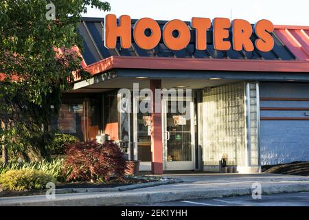 A logo sign outside of a Hooters restaurant location in King of Prussia ...