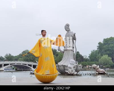 A tumbler performer dressed in Ancient Chinese clothes, dances for and ...