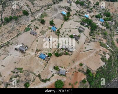 An aerial view of houses scattering on a cliff, where the cliff village ...