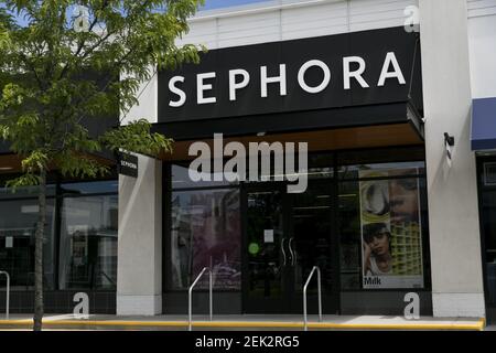 A logo sign outside of a Sephora retail store location in ...