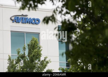 A logo sign outside of the headquarters of Avemco in Frederick ...