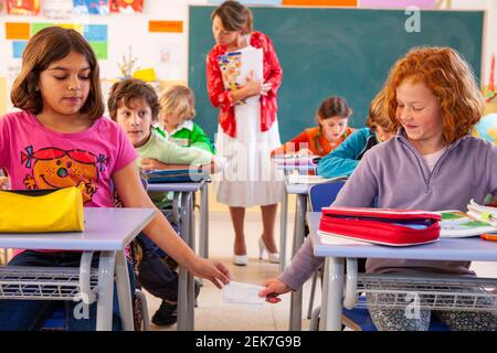 Children cheating in a school classroom Stock Photo - Alamy