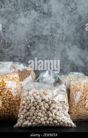 Different kinds of beans packed on a gray background Stock Photo - Alamy