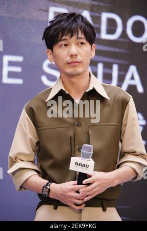 Chinese actor Bai Yu shows off elegance with a shirt on during a ...