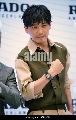Chinese actor Bai Yu shows off elegance with a shirt on during a ...
