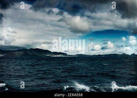 Waves splashing in sea against sky Stock Photo - Alamy