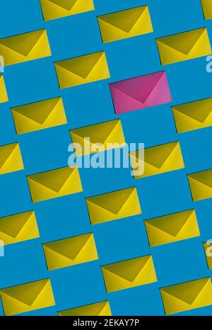 Pattern of rows of pink envelopes with single yellow one Stock Photo ...