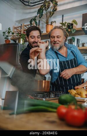 having fun. male chef in hat prepare healthy meal. handsome man with ...