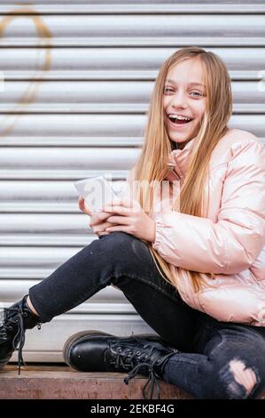 Cheerful positive blond girl clothing casual sitting at the salt flat ...
